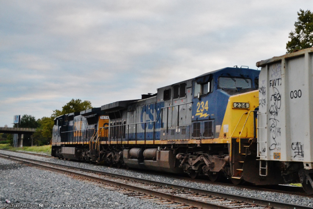 CSX 234 watches over the head end of trash loads.